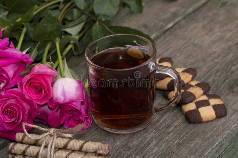 Glass of Tea and Cookies on a Plate with a Bouquet of Roses Stock Photo ...
