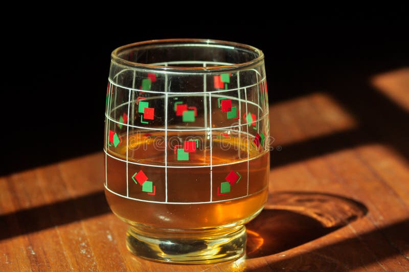 A Glass of Tea on the Table between the Shadow Lines of the House ...