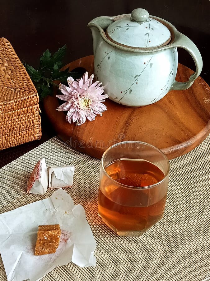 A Glass of Tea with a Teapot and a Snack at the Dining Table Stock ...