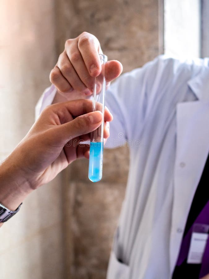Glass Test Tubes with Chemicals in the Hands. Chemical Experiments in a ...