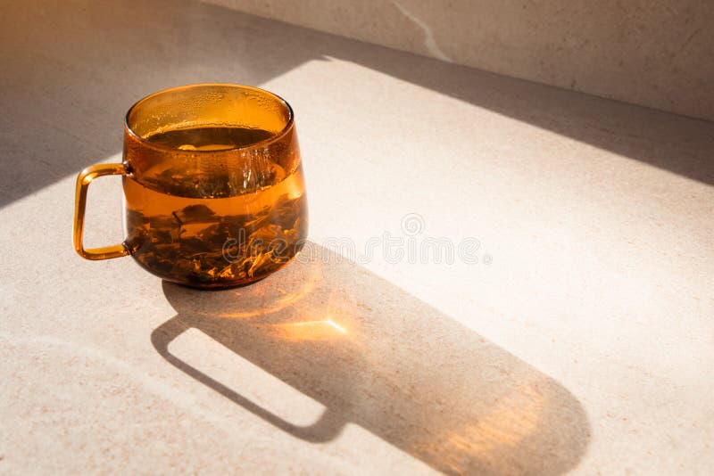 Glass Transparent Orange Mug with Hot Green Tea, Shadow and Reflection ...