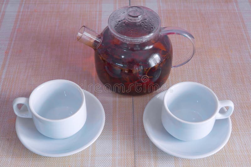 Glass Transparent Teapot with Black Tea and Two Empty White Cups on the ...