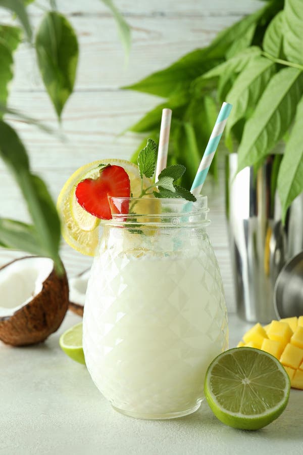 Glass of Tropical Cocktail and Ingredients on White Textured Table ...