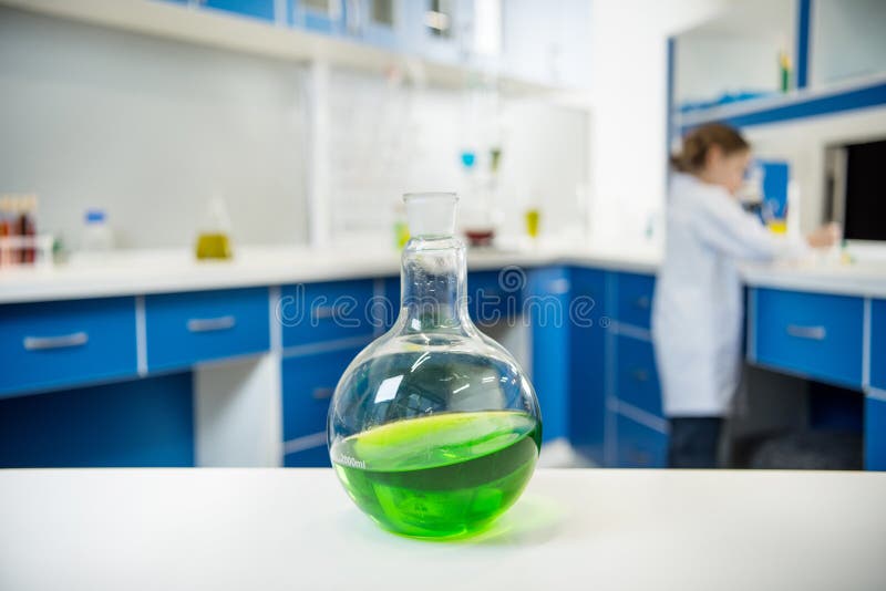 Glass Tube Wit Liquid on Lab Table with Scientist Behind Stock Photo ...