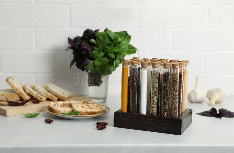 Glass Tubes with Different Spices and Plate of Sandwiches on Kitchen ...