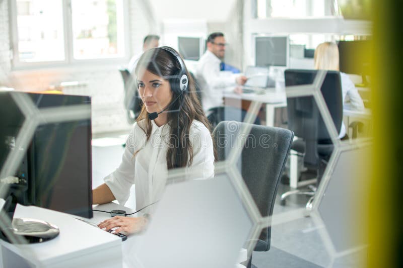 Through Glass View of Call Center Worker at Office. Stock Image - Image ...