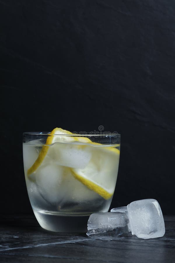 Glass of Vodka with Lemon Slices and Ice on Grey Table Stock Image ...