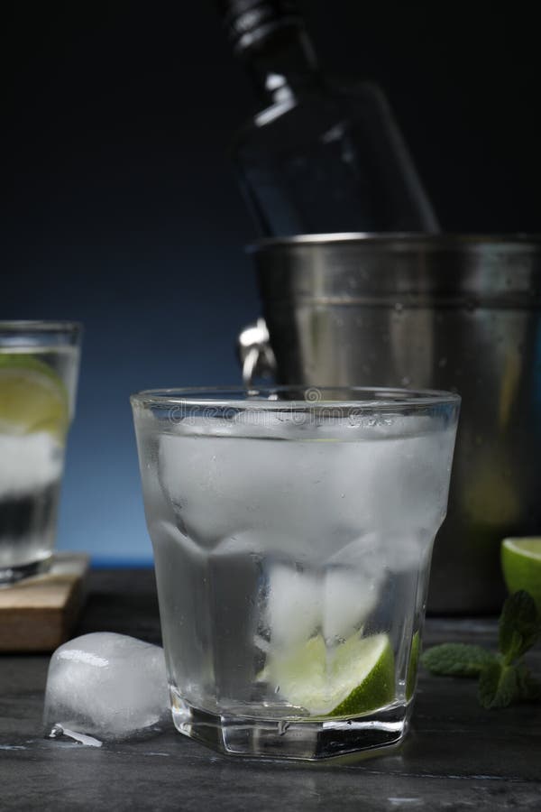 Glass of Vodka with Lime and Ice on Black Marble Table Stock Image ...