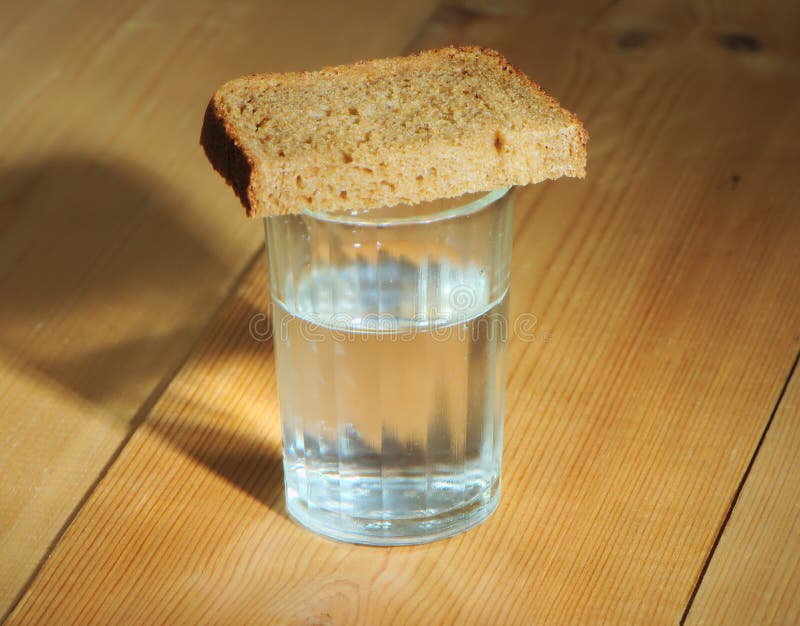 Glass of Vodka and a Slice of Bread on a Wooden Table Stock Image ...