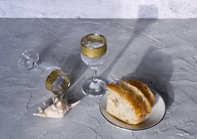 A Glass of Vodka, Sliced Bread and a Seashell Casting Long Shadows ...