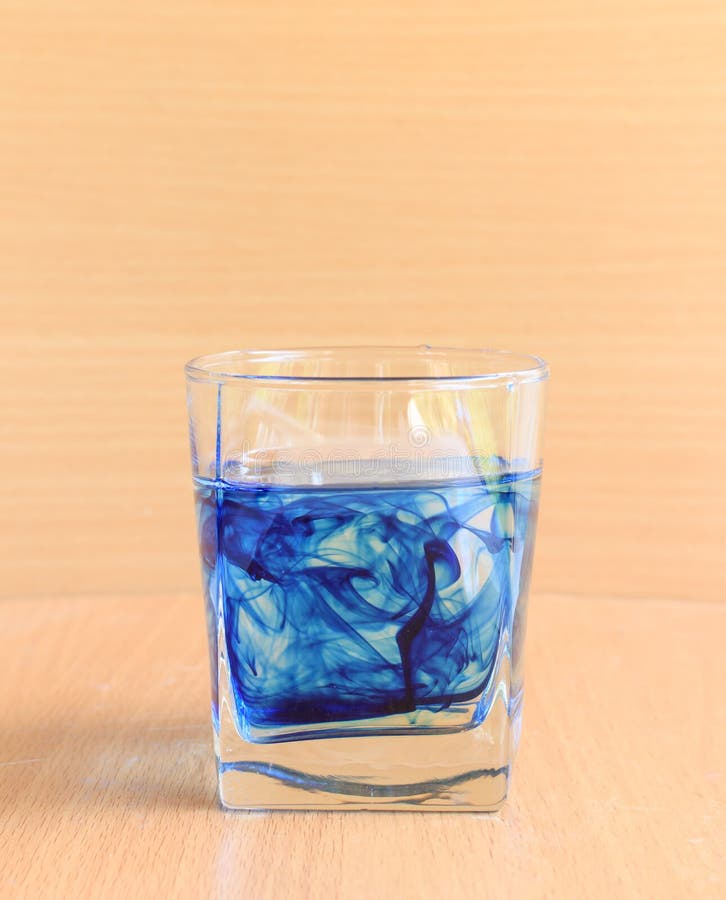 Glass of Water with Blue Liquid Stock Image - Image of bottle ...