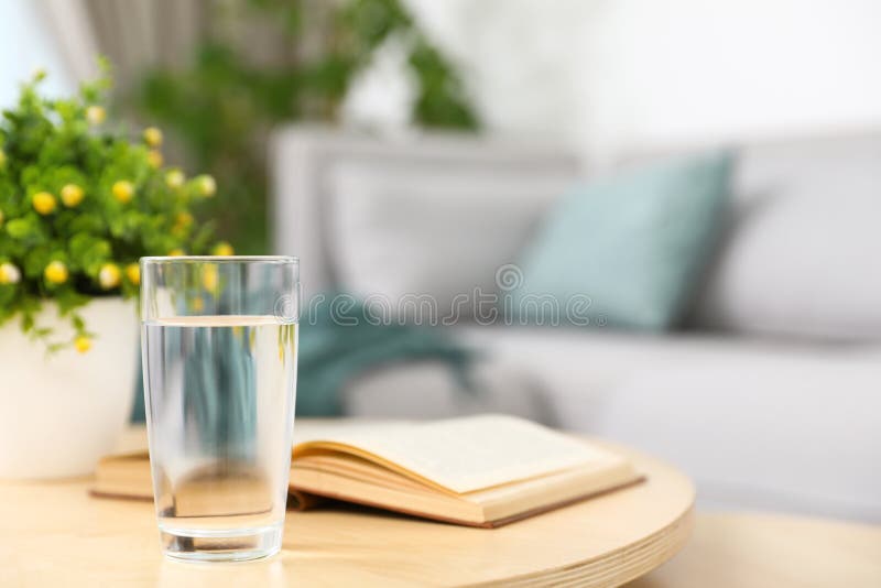 Glass of Water and Book on Coffee Table in Living Room Interior. Space ...