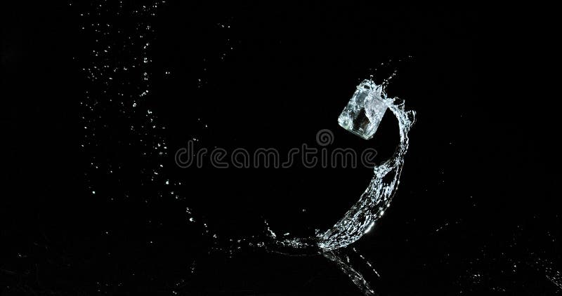 Glass of Water Bouncing and Splashing on Black Background Stock Image ...