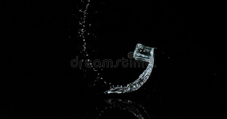 Glass of Water Bouncing and Splashing on Black Background Stock Photo ...