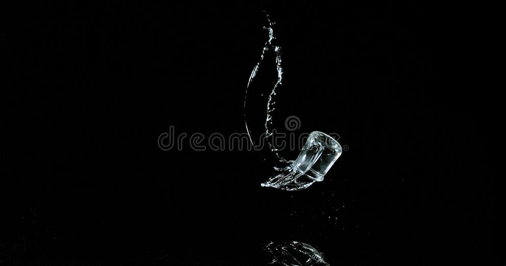 Glass of Water Bouncing and Splashing on Black Background Stock Image ...