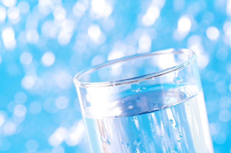 Glass of Water on Defocused Sparkle Background. Stock Photo - Image of ...