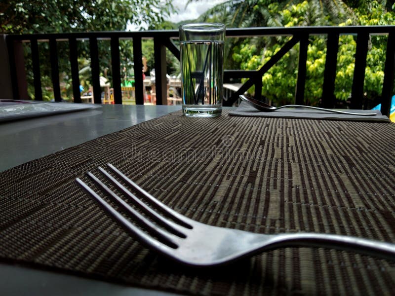 A Glass of Water and Fork Spoon Put on the Table Stock Image - Image of ...