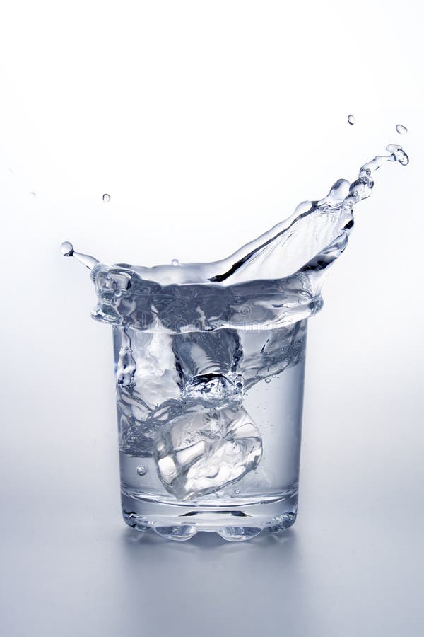 Ice Cube Splashing into Water with Water Fountain Stock Image - Image ...