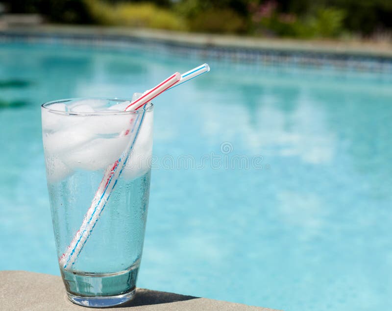 Glass of Water with Ice Cubes on Side of Pool Stock Photo - Image of ...