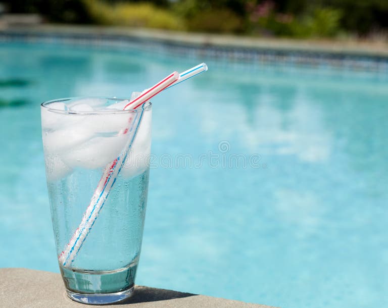 Glass of Water with Ice Cubes on Side of Pool Stock Photo - Image of ...