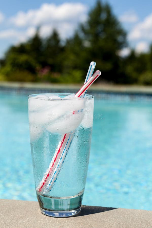 Glass of Water with Ice Cubes on Side of Pool Stock Photo - Image of ...
