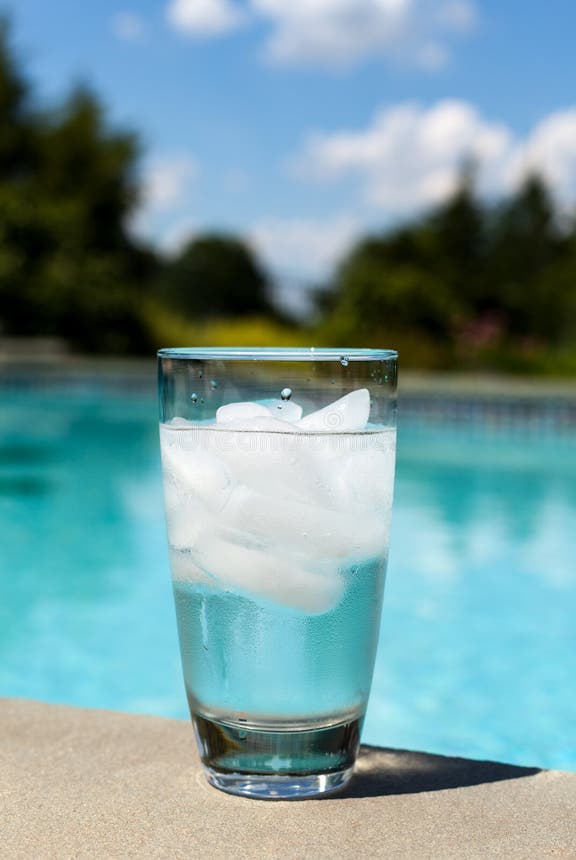 Glass of Water with Ice Cubes on Side of Pool Stock Image - Image of ...