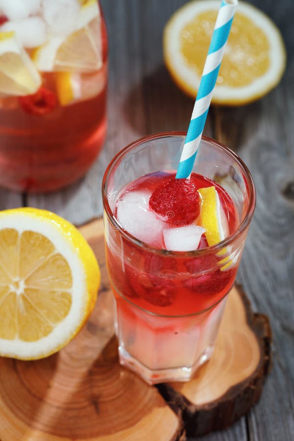 Glass of Water with Raspberries, Slices of Lemon and Ice Stock Photo ...