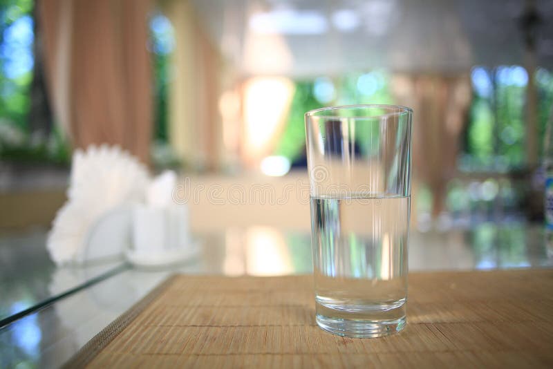 Glass of water on a table stock image. Image of alcohol - 62133101