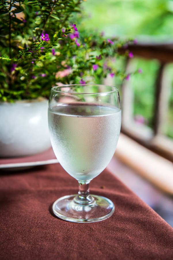 Glass with water on table stock photo. Image of cool - 172346226