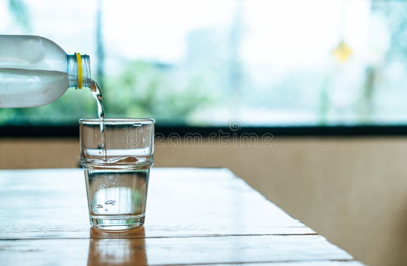 Glass of water on table stock photo. Image of outdoors - 205933400