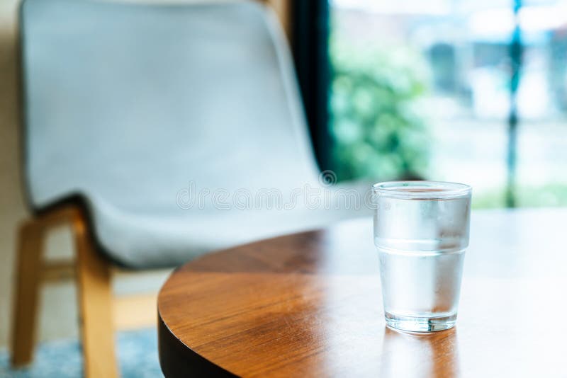 Glass of water on table stock photo. Image of liquid - 223569606