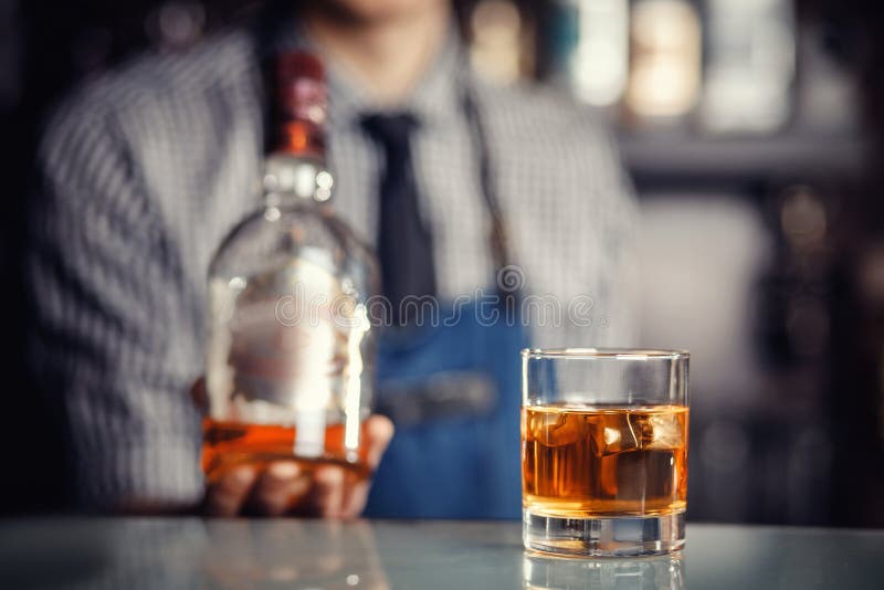 Glass of Whiskey with Ice is on Bar, Bartender Ready To Fill Shot Stock ...