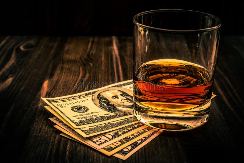 Glass of Whiskey with Money on a Wooden Table. Stock Image - Image of ...