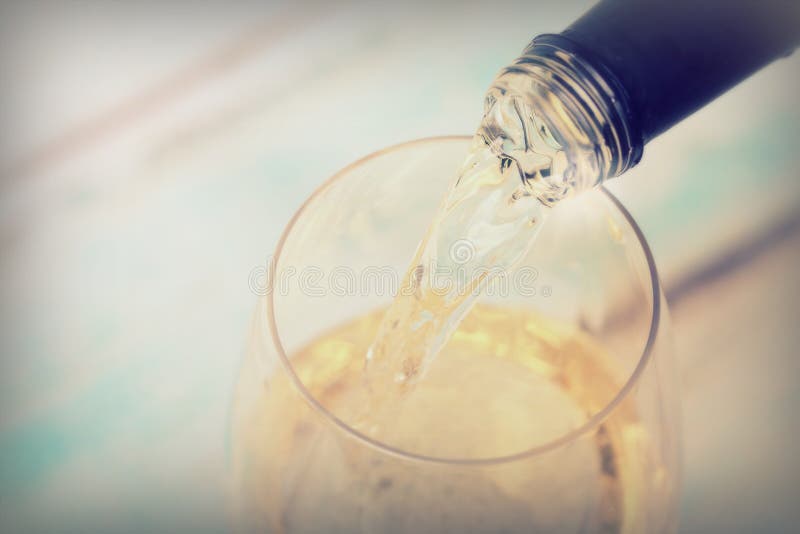 Glass of White Wine Being Poured from Bottle Stock Photo - Image of ...