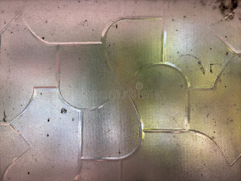 A Glass Window with a Pattern of Squares and Circles Stock Photo ...