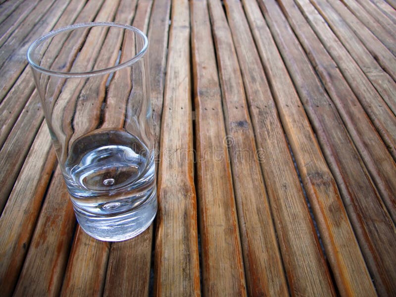 Glass on a wood table top stock photo. Image of texture - 1688996