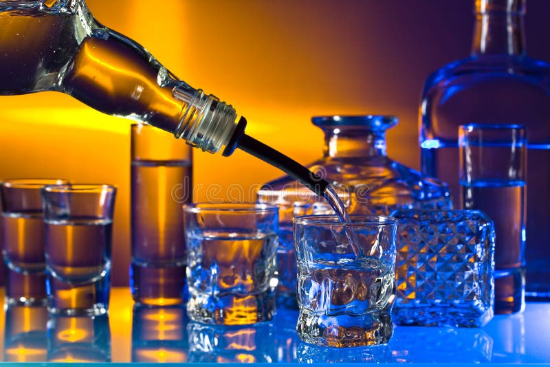 Glasses with Alcoholic Drinks on a Glass Table in Bar Stock Photo ...