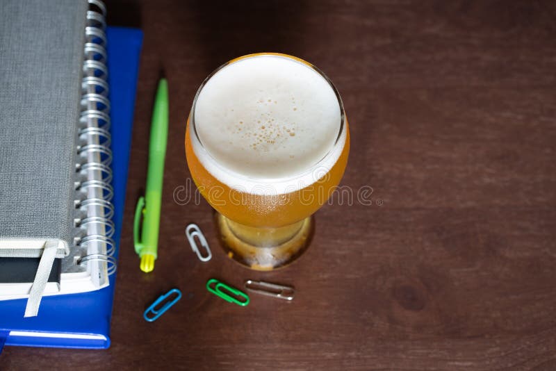 Glasses of Beer and Office Accessories on Wooden Table Stock Image ...