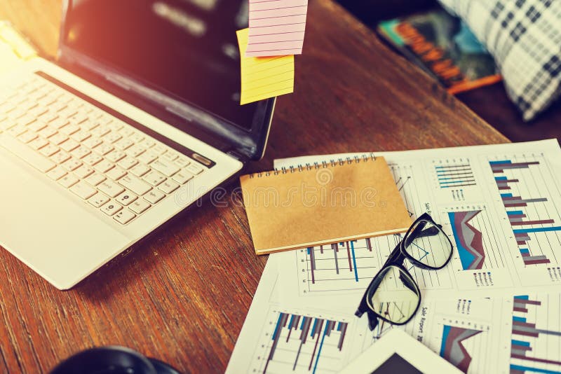 Glasses, Book, Paper Graph and Laptop on the Table Stock Photo - Image ...