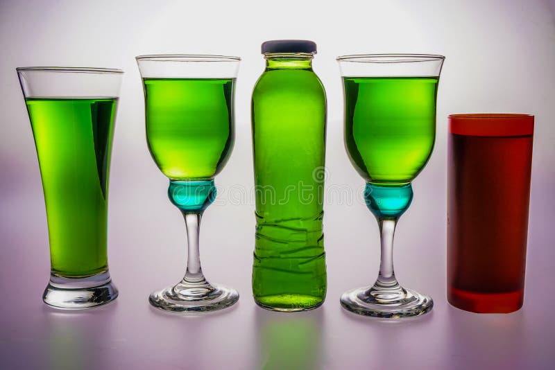 Glasses and Bottle Filled with Green Liquid Stock Photo - Image of ...