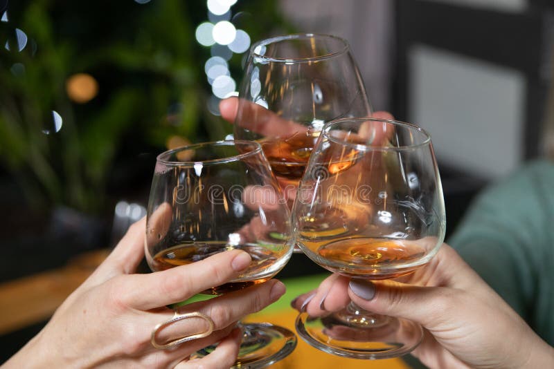 Glasses of Brandy Held in Hands Stock Photo - Image of alcohol, bourbon ...
