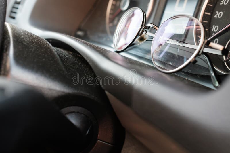 Glasses on the Dashboard of a Car. Accessory for Drivers with Vision ...