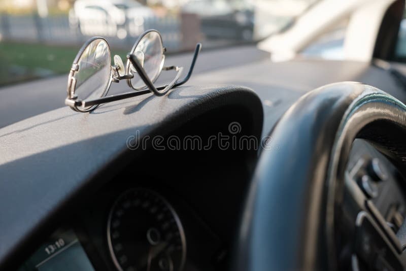 Glasses on the Dashboard of a Car. Accessory for Drivers with Vision ...