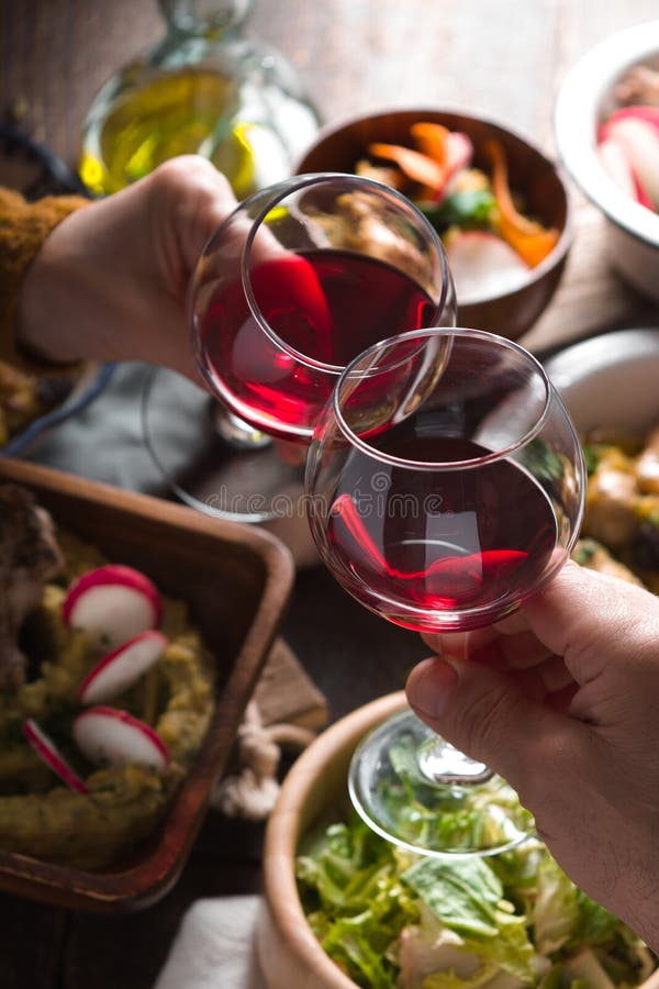 Glasses with a Drink in Hand and Salads on the Table Stock Image ...