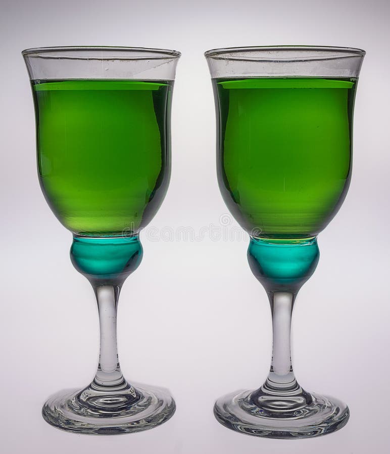 Glasses Filled with Green Liquid on Graduated Background Stock Photo ...