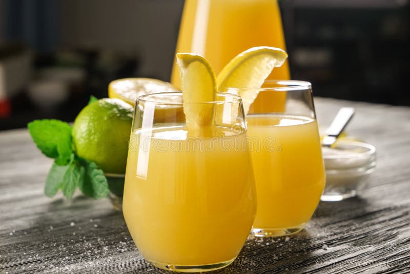 Glasses of Fresh Lemon Juice on Wooden Table Stock Image - Image of ...