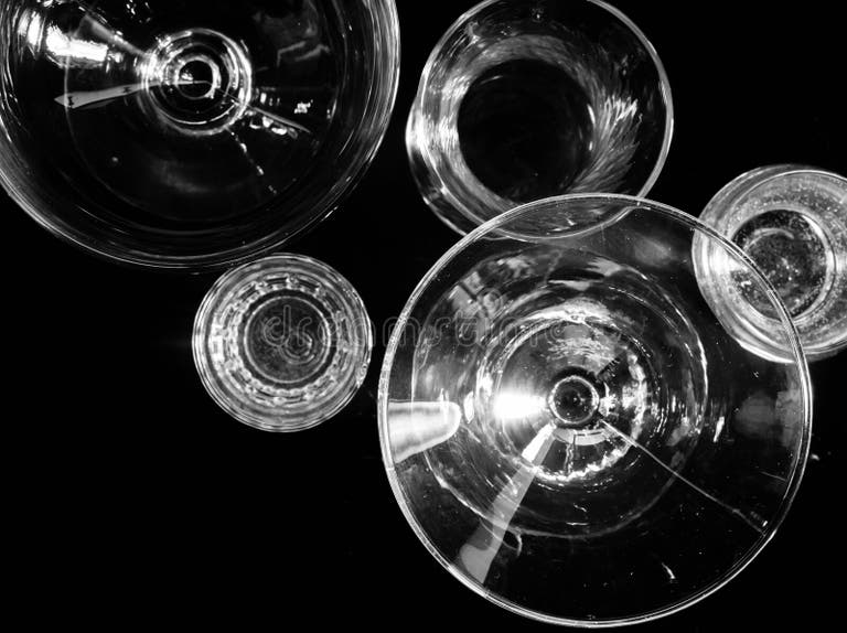 Glasses and Glasses Highlighted by Colored Light on a Black Background ...