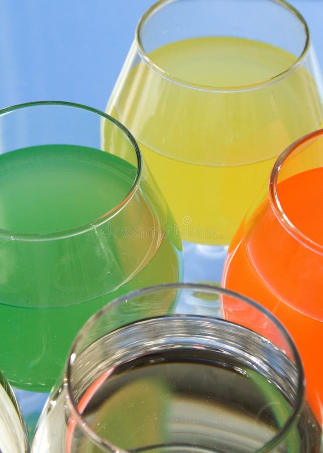 Glasses with Green, Yellow, Water on a Mirror Stock Photo - Image of ...