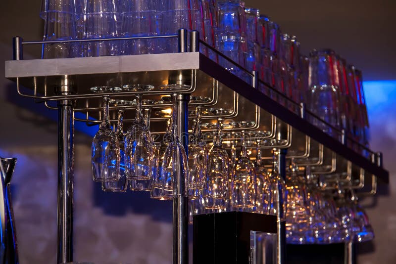 Glasses hang over the bar stock photo. Image of business - 148641524