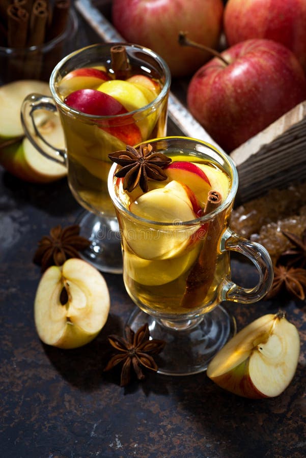 Glasses of Hot Apple Tea with Spices on Dark Table, Vertical Stock ...